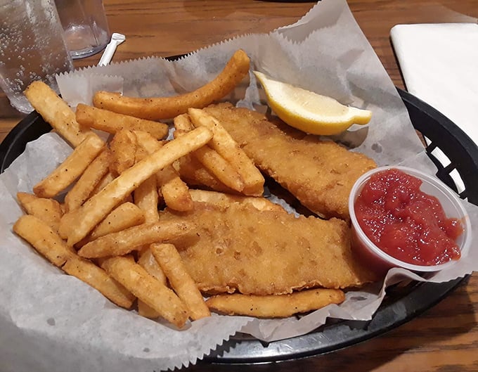 Fish and chips served unpretentiously in a basket&mdash;crispy, golden, and ready to transport you to seaside memories without the sand in your shoes.