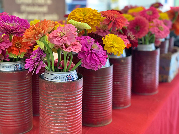 Flowers so vibrant they make Instagram filters redundant, cleverly displayed in repurposed beer cans. Martha Stewart meets MacGyver in the best possible way.