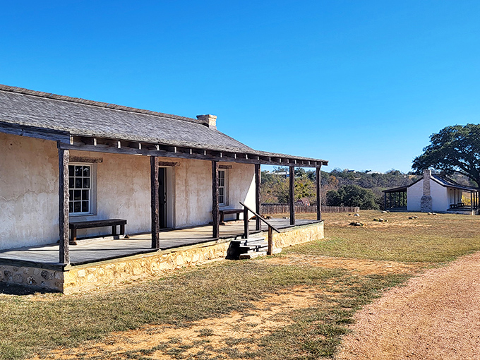 Fort Martin Scott whispers tales of frontier life, its simple porch a stage where history played out under the same Texas sky.