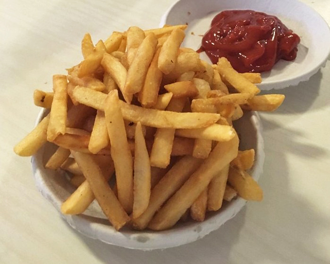 Golden fries piled high, each one a crispy little miracle waiting for its ketchup destiny.
