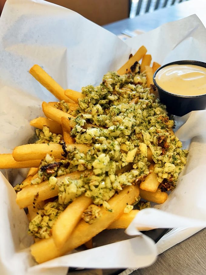 Garlic fries that don't whisper, they announce themselves. These golden treasures aren't just a side dish&mdash;they're the main event with a supporting cast of dipping sauce.