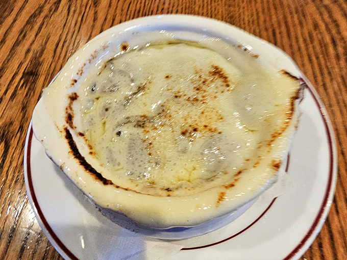 This French onion soup isn't messing around &ndash; that cheese pull could win Olympic medals, and the broth beneath promises depths of flavor.