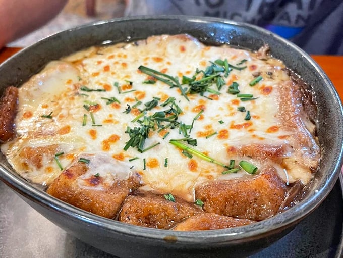 Cheese stretching to infinity atop a bubbling cauldron of French onion soup&mdash;proof that patience and proper broiling can create edible art.