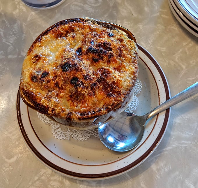 Behold the French onion soup&mdash;a bubbling cauldron of cheese and comfort that requires both spoon and strategy to navigate properly.
