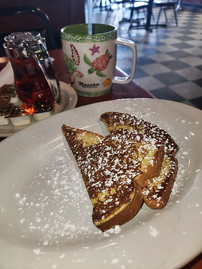 A dusting of sugar, a perfect golden slice. This French toast, alongside a hot cup of coffee, is the ultimate way to start any day.