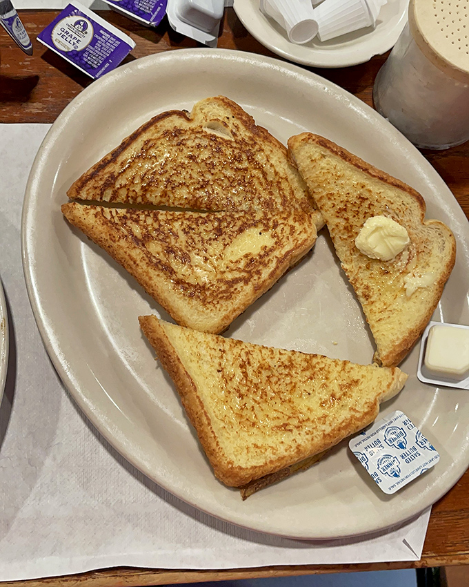 Toast that's achieved golden perfection. This isn't just bread that's been heated &ndash; it's a canvas of butter-soaked breakfast artistry.