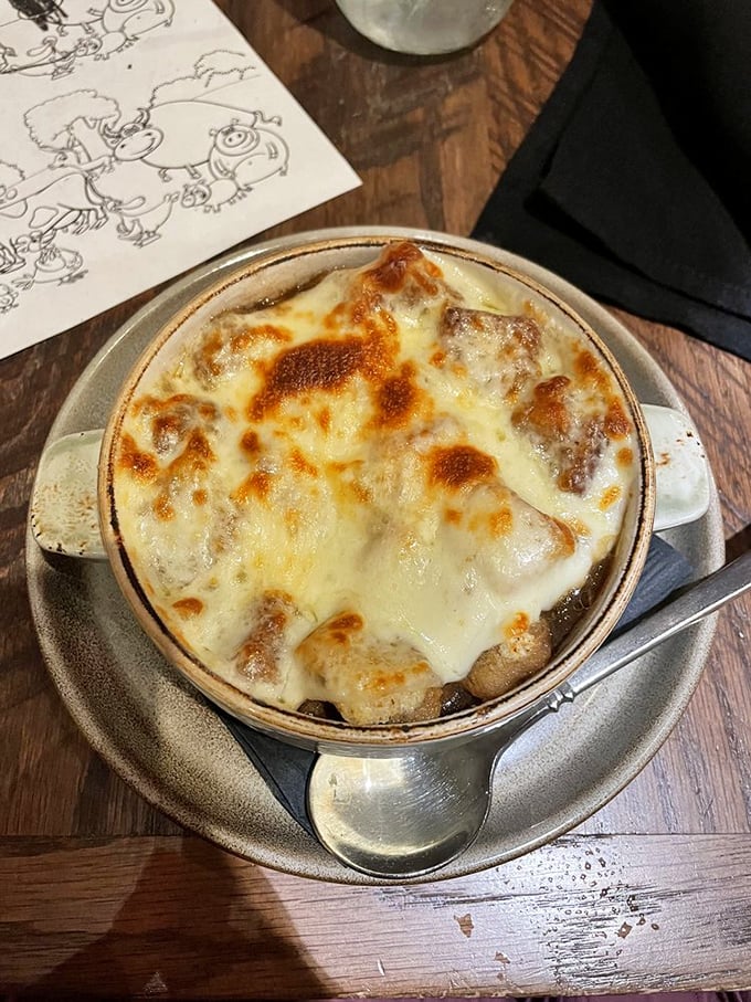 French onion soup with a cheese pull that deserves its own Olympic event. That golden crust is what dreams are made of.