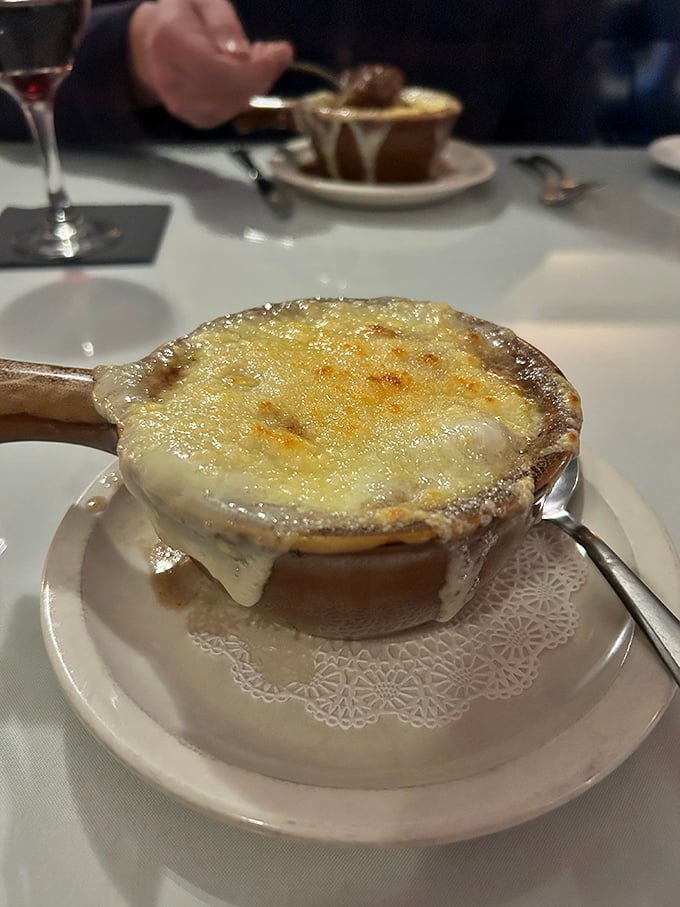 Now that's a cheese pull! This French onion soup, with its rich broth and blanket of bubbly, golden cheese, is pure indulgence.