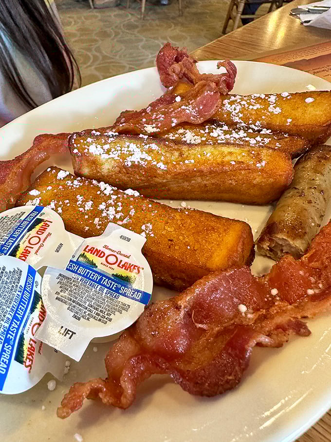 French toast dusted with powdered sugar and bacon cooked to that perfect crisp-chewy balance. Breakfast nirvana exists, and it's right here.