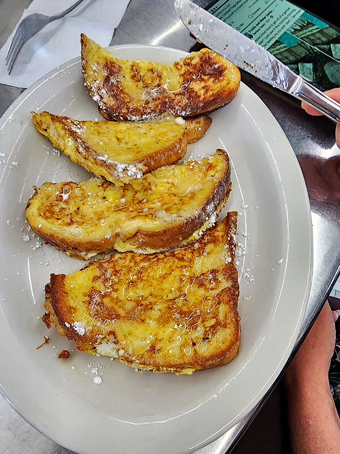 French toast dusted with powdered sugar, golden and ready to make your morning sweeter than you planned.