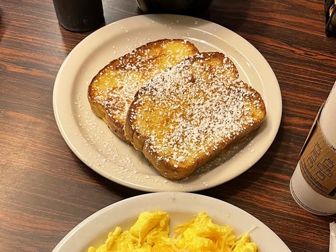 French toast dusted with powdered sugar like the first gentle snowfall, waiting to be drizzled with syrup and paired with those sunshine-yellow scrambled eggs.