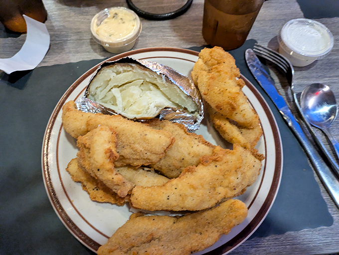 Golden-fried perfection alongside a baked potato that's dressed better than most people at the Oscars. Comfort food elevated to art.