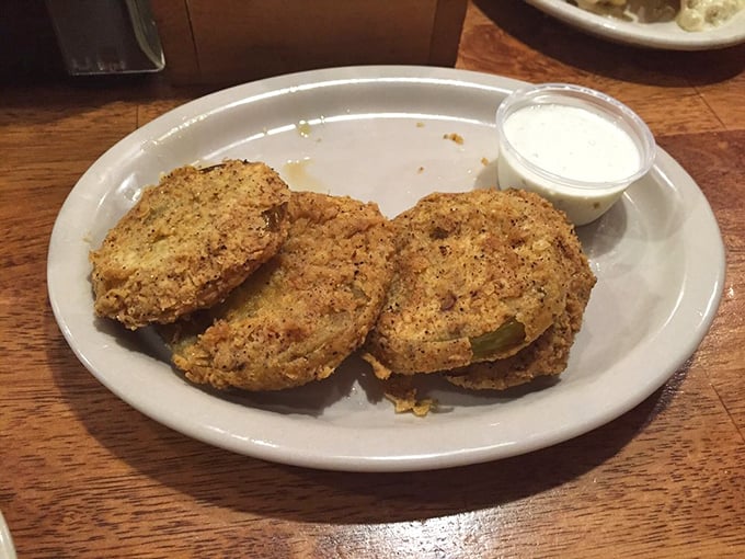Fried green tomatoes: the South's gift to civilization. Crispy cornmeal exterior gives way to tangy interior&mdash;a textural masterpiece worth crossing state lines for.