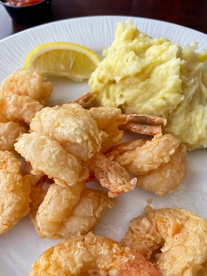 Fried shrimp so perfectly golden they deserve their own trophy, paired with mashed potatoes that clearly weren't born from a box.