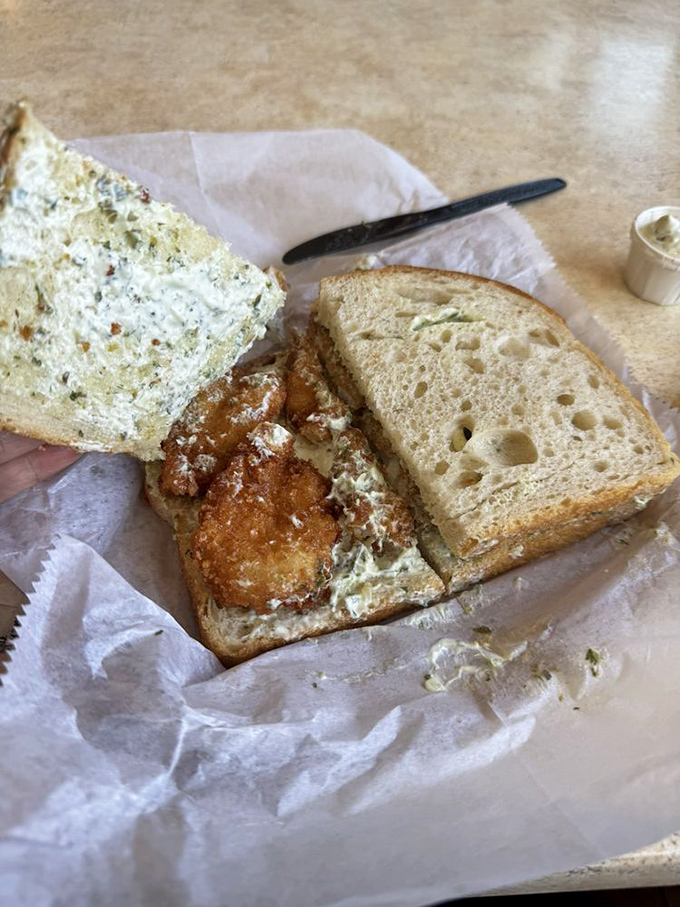 Golden-fried perfection nestled between bread &ndash; proof that sometimes the simplest pleasures are the most satisfying.