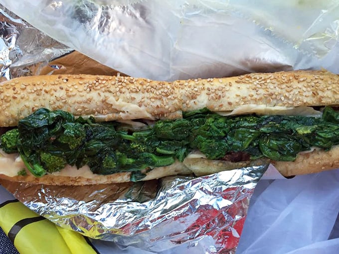 A sesame-seeded roll cradling bright green broccoli rabe and roast pork. The bitter greens and savory meat create that perfect balance that keeps Philly coming back.