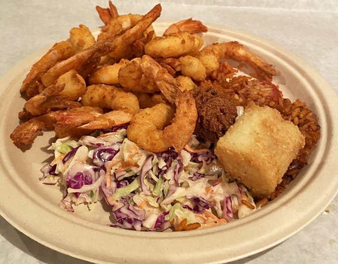 This mountain of perfectly fried shrimp isn't just a meal&mdash;it's a celebration of the sea, complete with crispy companions and a rainbow slaw that adds just the right amount of crunch.