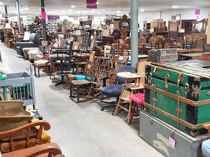 Furniture alley stretches into the distance like a living room time tunnel. That green trunk probably held someone's hopes and dreams before landing here.