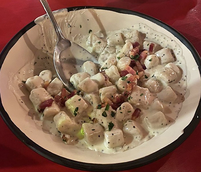 Pillowy gnocchi swimming in creamy sauce with pancetta &ndash; like little potato clouds that decided to party with bacon. Heaven exists on this plate.