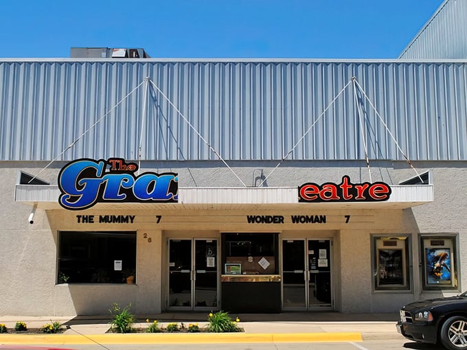 The Grand Theatre marquee promises Hollywood escapes at small-town prices. Where else can you see blockbusters without blockbuster-sized holes in your wallet? 