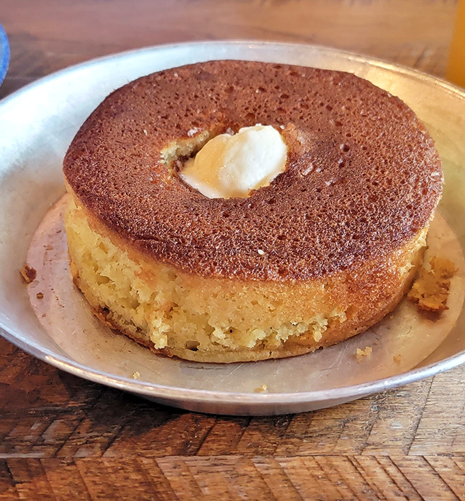 This griddle cake sits there like a fluffy golden crown, daring you to resist its buttery magnificence.