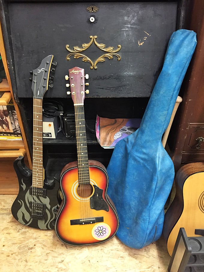 Musical history leaning casually against vintage furniture. These guitars aren't just instruments; they're vessels of memories waiting for new hands.