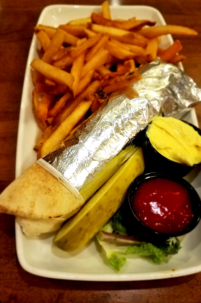 Wrapped in foil like a present waiting to be unwrapped. This gyro comes with crispy fries and the promise of Mediterranean bliss.