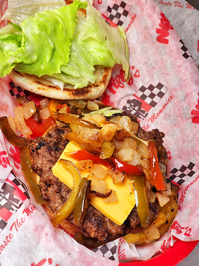 This isn't just a burger—it's an architectural marvel of beef, cheese, and grilled vegetables that requires a game plan before the first bite.