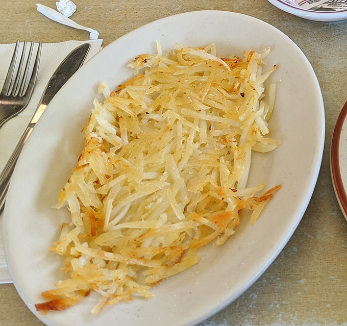 Hash browns that achieve the impossible: uniformly golden, crispy edges with not a soggy strand in sight. This is potato perfection, my friends.