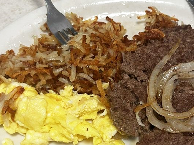 The breakfast trifecta: golden hash browns, perfectly scrambled eggs, and a hamburger steak. Vacation calories don't count, especially before noon.
