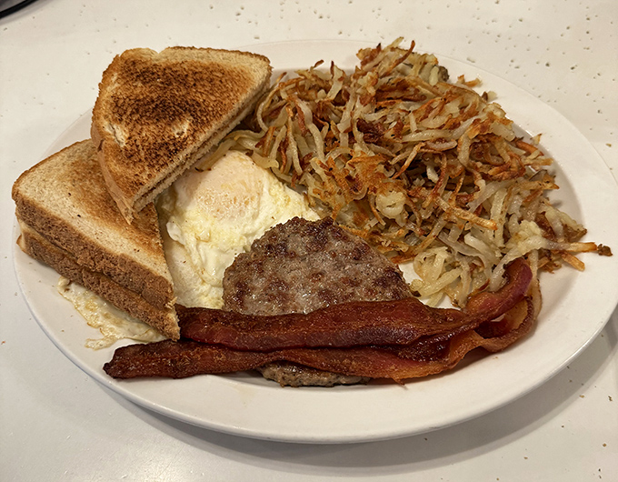 The breakfast trinity &ndash; perfectly toasted bread, eggs your way, and hash browns crisped to golden perfection. Simple food done right is culinary poetry.
