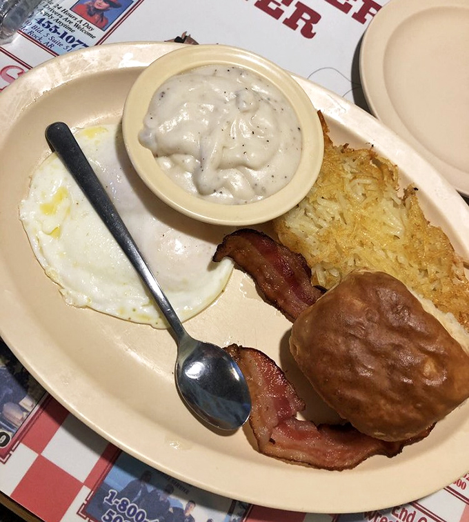 The holy trinity of breakfast: perfectly fried egg, country ham, and a biscuit that could make a Southern grandmother weep with joy.