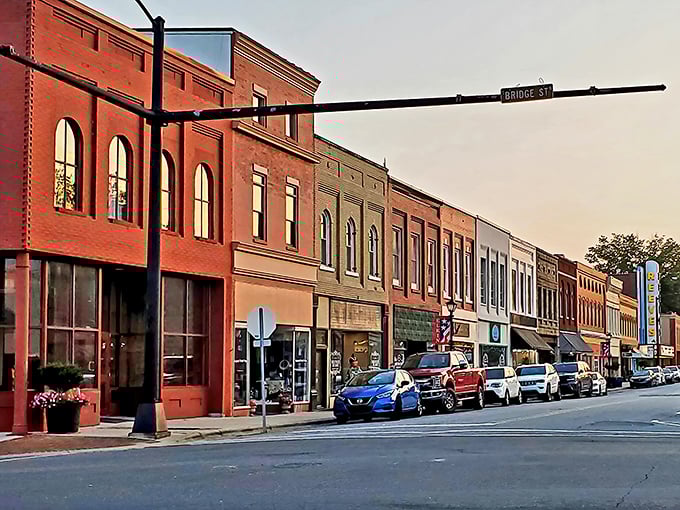 Bridge Street's historic buildings stand like old friends in conversation, their brick facades warmed by the golden hour light.