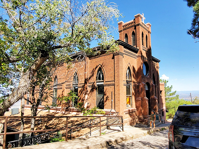 Holy Family Church's red brick exterior has weathered decades on this mountainside, standing firm while everything else slid downhill.