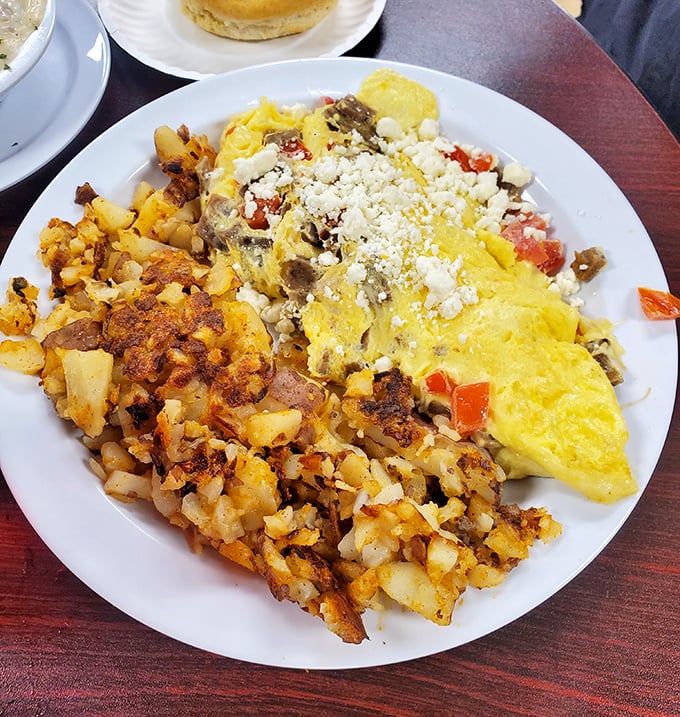 A masterpiece of home fries and omelet artistry. The crispy-to-fluffy ratio here deserves its own mathematical equation.