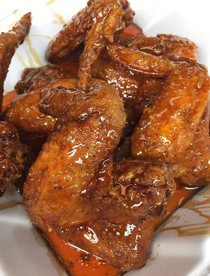 Wings glazed like precious gems, each one a sticky, sweet masterpiece worth savoring slowly.