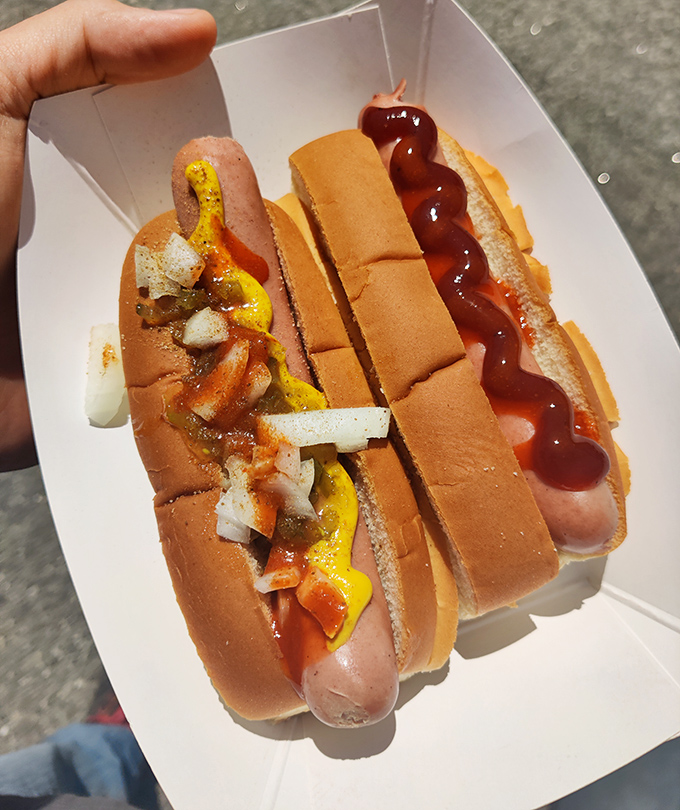 Hot dogs done right—dressed with mustard, onions, and ketchup, they're proof that simplicity often trumps complexity in the food world.