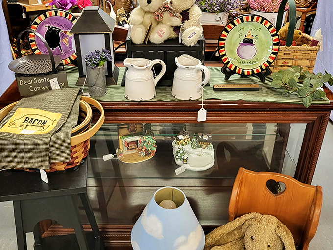 Country charm meets whimsical decor in this display where ceramic pitchers and teddy bears coexist like old friends at a reunion.