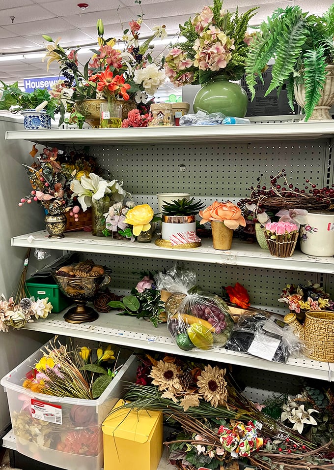 Artificial flowers and décor items line shelves like a colorful garden where everything costs pocket change.