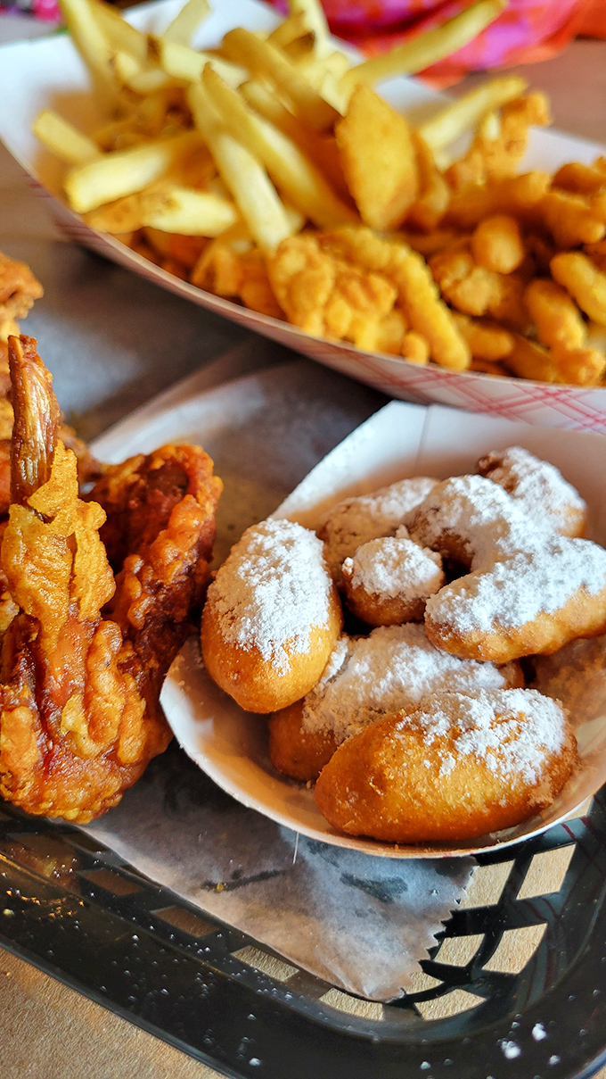 Hush puppies dusted with powdered sugar sit alongside crispy chicken and fries&mdash;proof that sometimes the best things come in small packages.