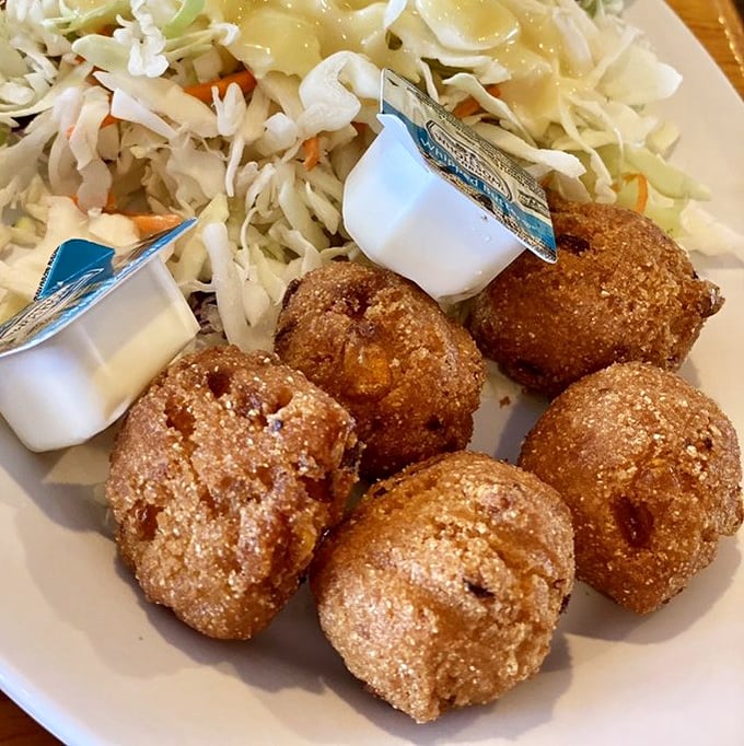 Hushpuppies so perfectly golden they deserve their own trophy. Crispy exterior, fluffy interior&mdash;the unsung heroes of the seafood feast.