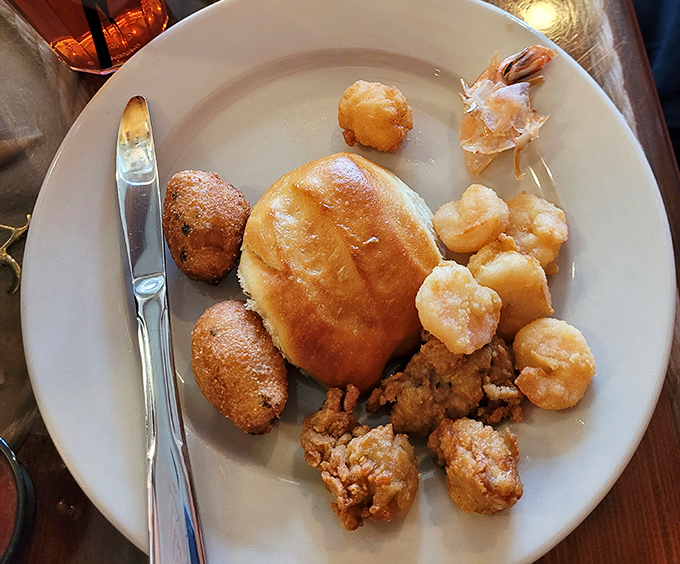 Southern hospitality on a plate—golden hushpuppies and fried delights that would make your grandmother nod in approval while reaching for another.
