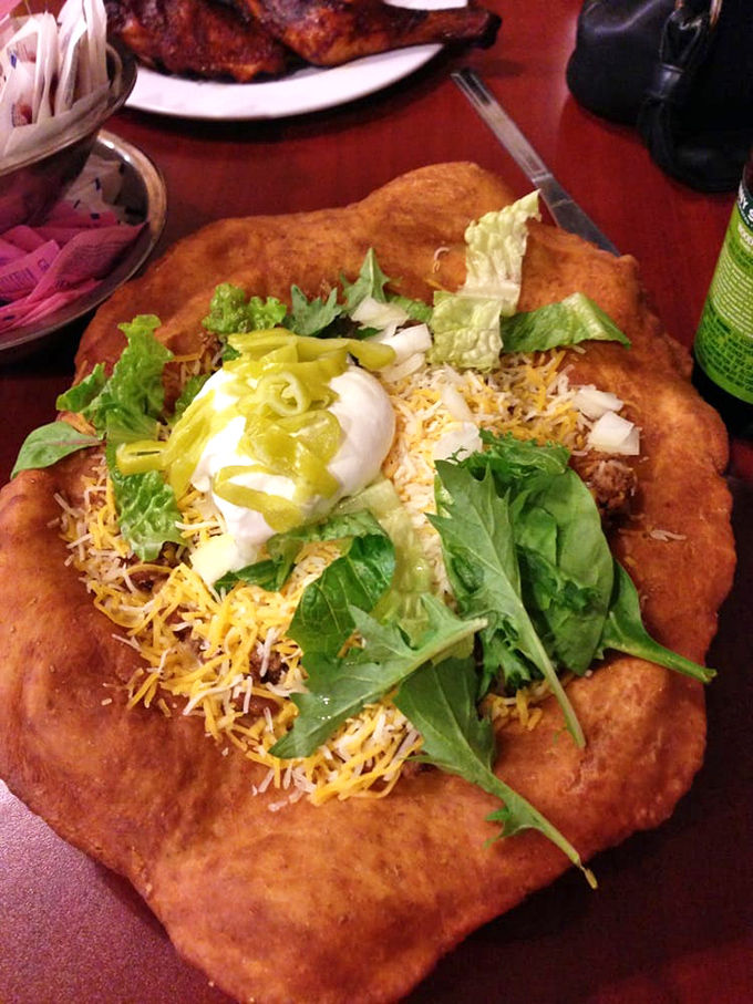 The Indian fry bread taco arrives like an edible canvas, painted with vibrant toppings that transform a regional specialty into a work of art.