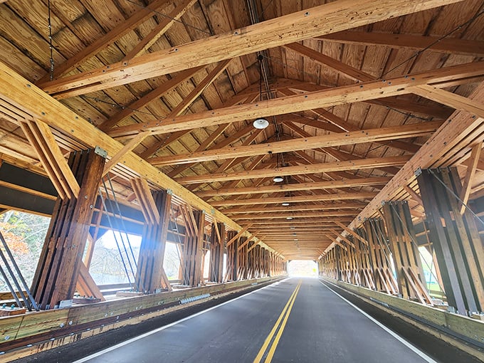 Inside the covered bridge, wooden beams create a cathedral-like passage where every creak tells stories of travelers past.