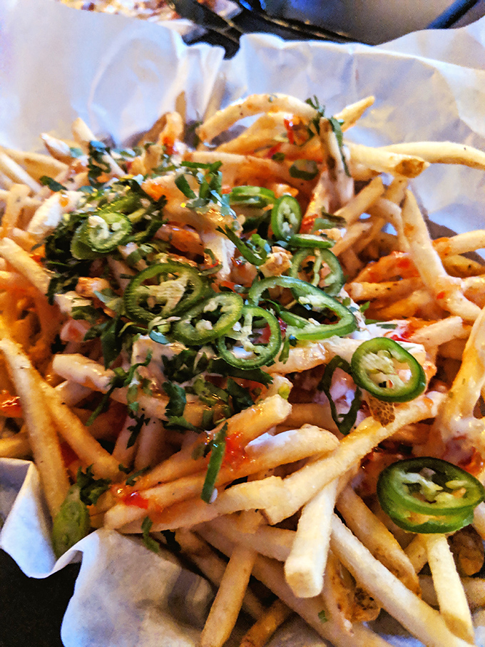 These aren't just fries; they're a spicy, herbaceous delivery system for happiness, topped with enough jalapeños to wake up your taste buds.