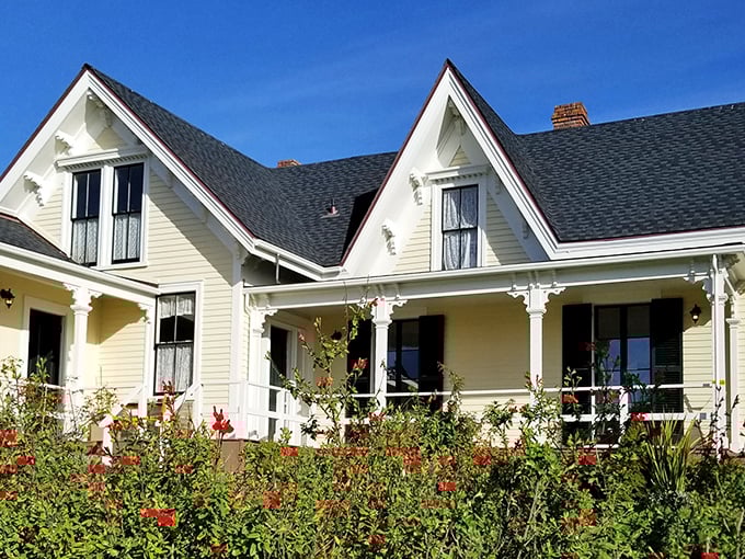 The quintessential Mendocino postcard: white picket fences, colorful gardens, and the Pacific Ocean playing backdrop like it's showing off.