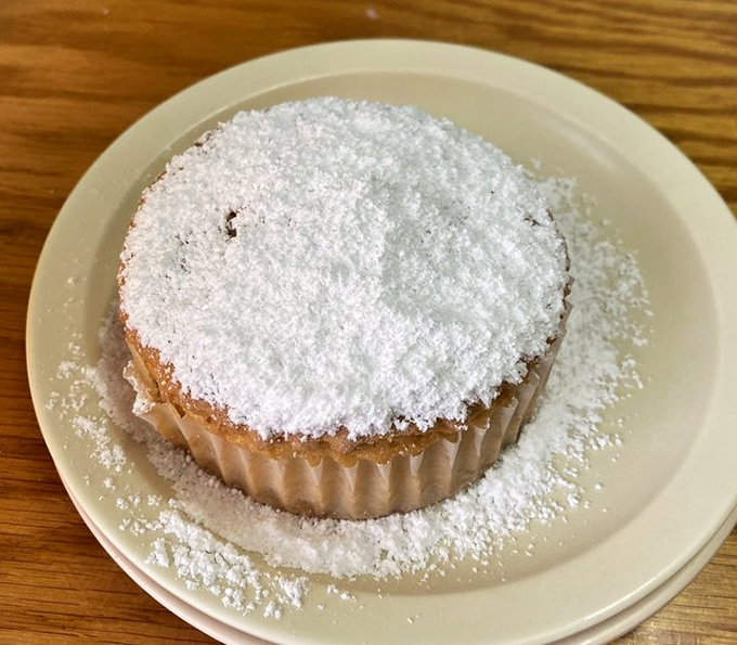The Key Lime muffin, dusted with powdered sugar like a tropical snowfall, delivers the perfect balance of tart and sweet in every bite.