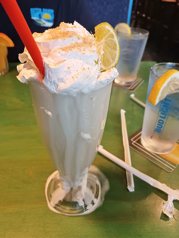 The key lime shake arrives like a vacation in a glass &ndash; topped with whipped cream, graham cracker crumbs, and a lime wedge hat.