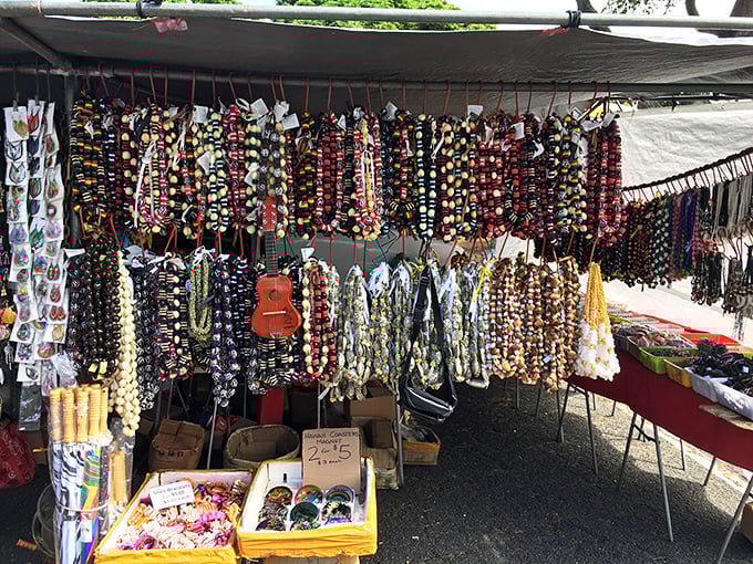 Handcrafted shell and kukui nut leis hang in colorful rows &ndash; wearable art that captures Hawaii's natural beauty without wilting.