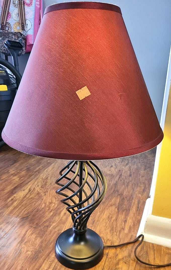 Not just a lamp, but a conversation piece waiting to illuminate your living room. That burgundy shade has seen things, and now it's ready for a second act.